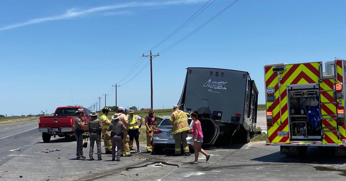 WATCH: Dangerous Crash Leaves Car Crushed Under Travel Trailer at Wall